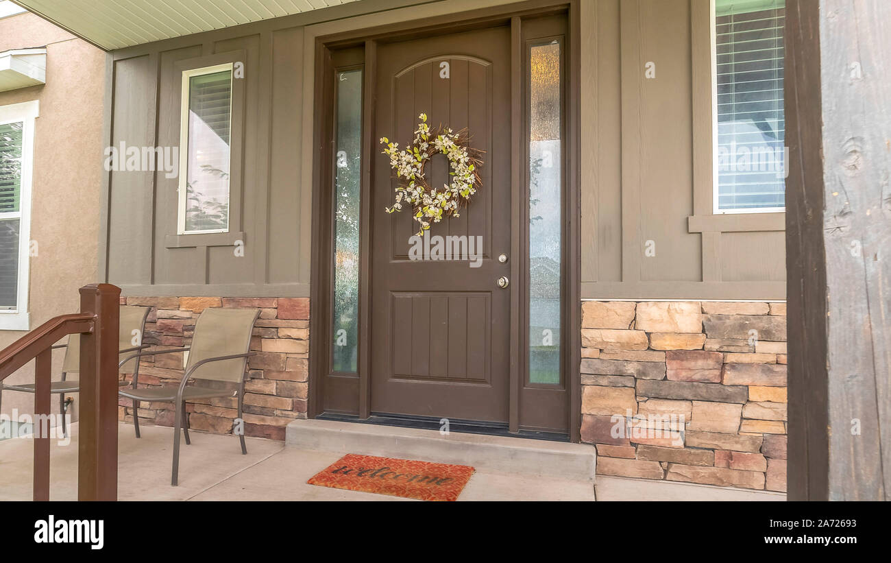 Panorama Porch and front door of a home with wood and stone brick wall ...