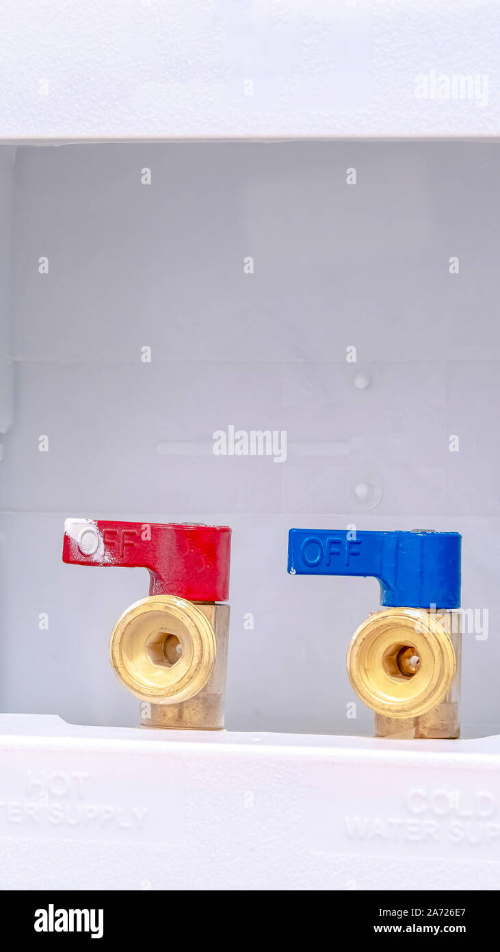 Vertical frame Hot and cold water connectors in a laundry room Stock ...