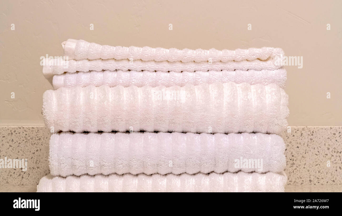Panorama frame Stack of clean white ribbed towels in a bathroom Stock ...