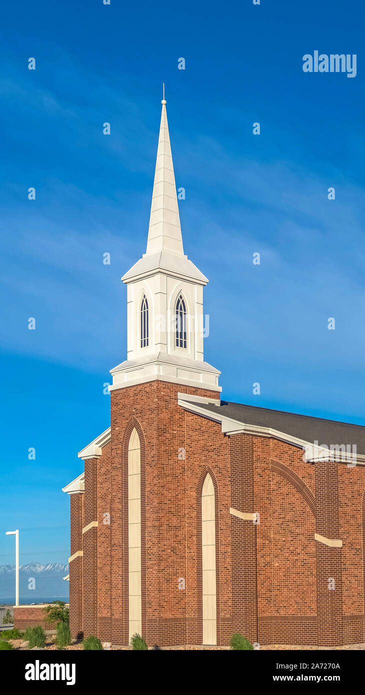Vertical frame Exterior of a church with red brick wall arched windows ...