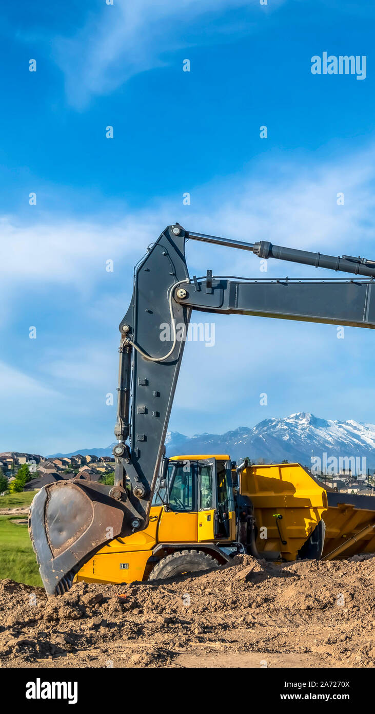 Vertical frame Excavator with metal arm and bucket and continuous ...