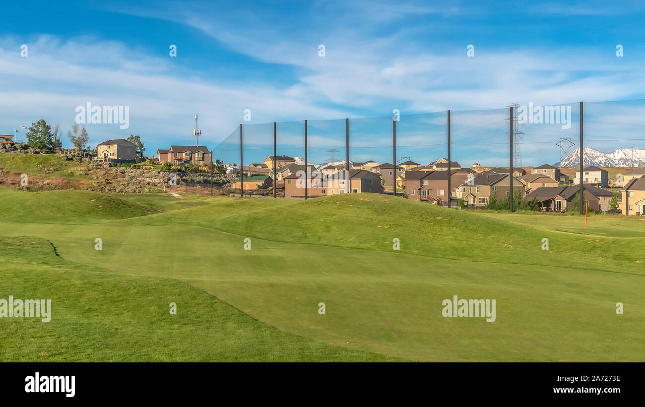 Panorama frame Focus on a sand trap surrounded by short green grasses ...
