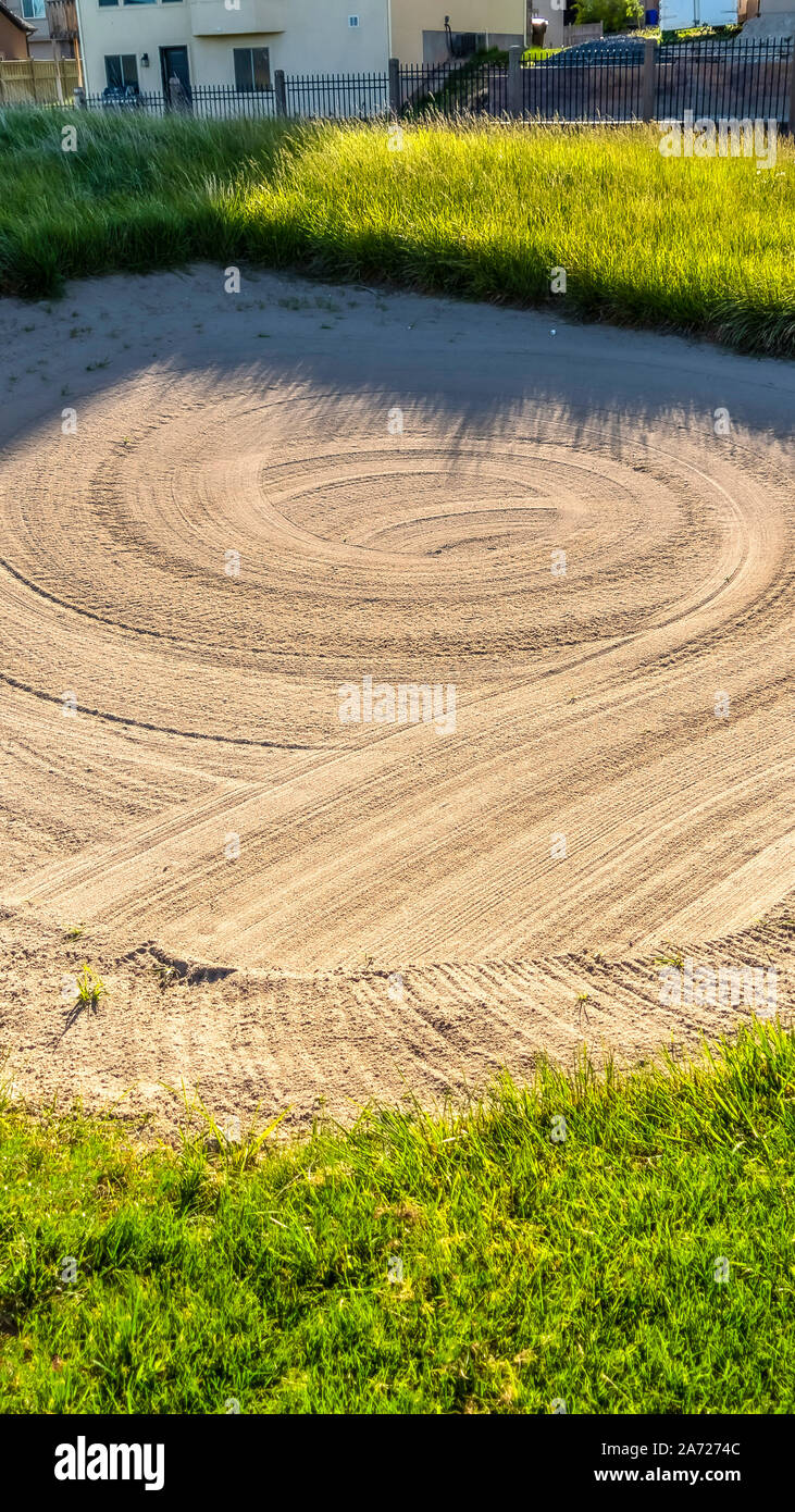 Vertical frame Close up of a sand trap surrounded by grasses at a golf ...