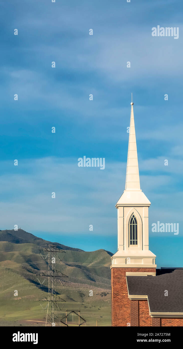 Vertical frame Rooftop and steeple of a church against power lines ...