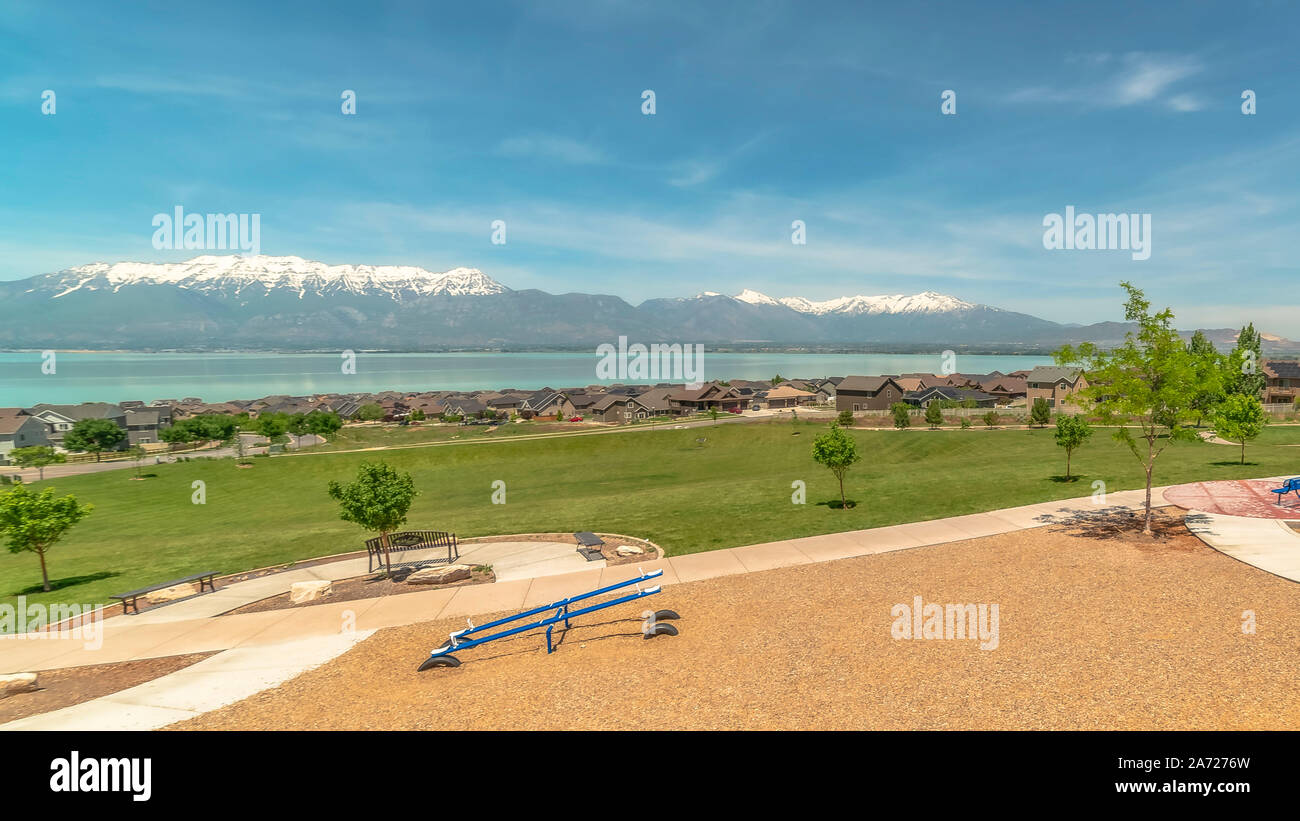 Panorama Lake and snow capped mountain viewed fron a park with colorful ...