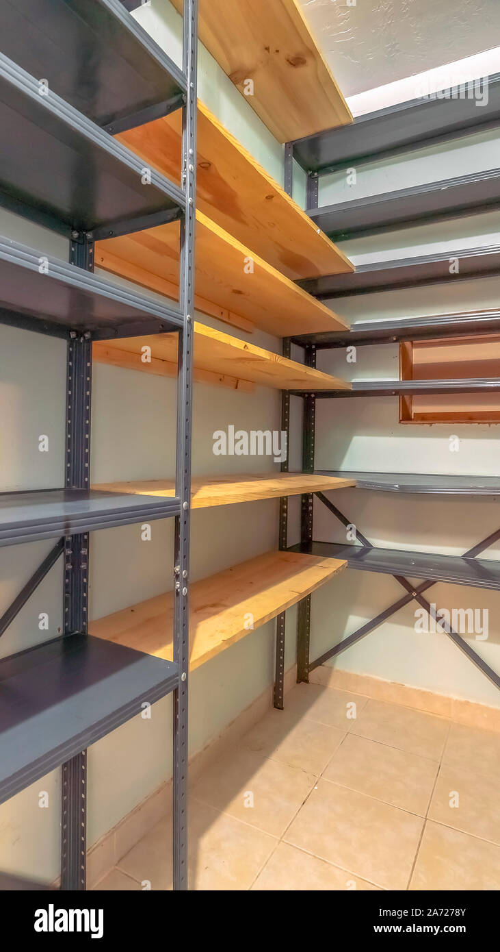 Vertical Interior of a small empty closet with metal and wood shelves ...