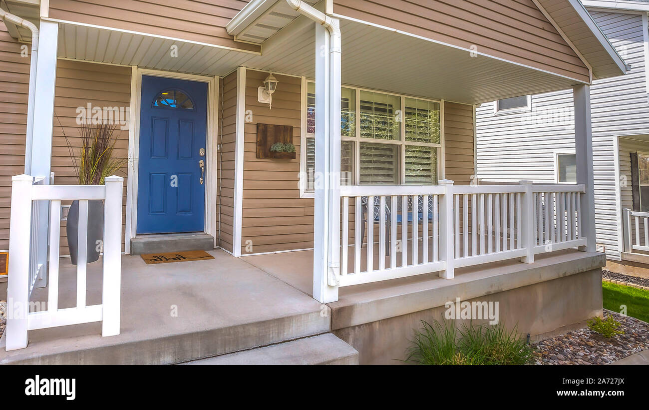 Panorama frame Front view of a home with cozy porch and glass paned ...