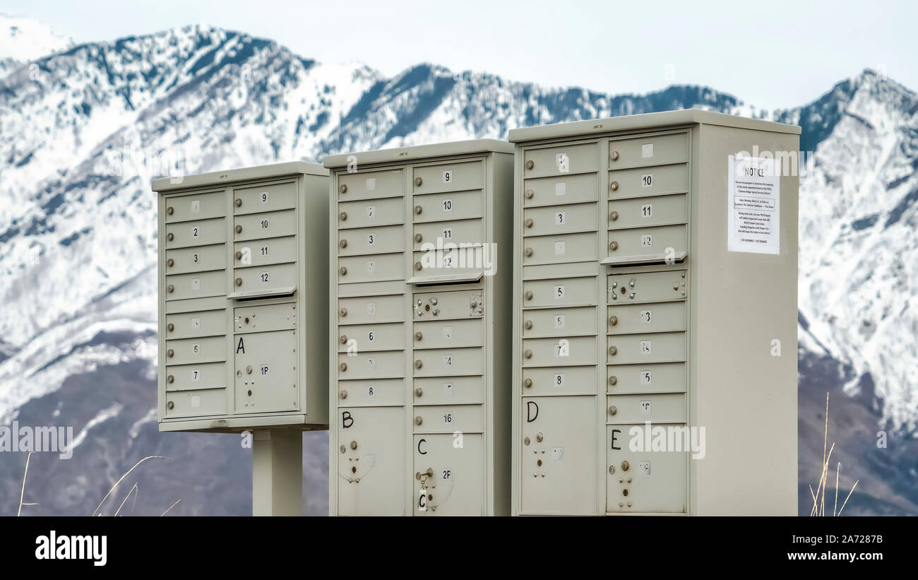 Panorama Mailboxes with compartments and numbers against snowy mountain ...