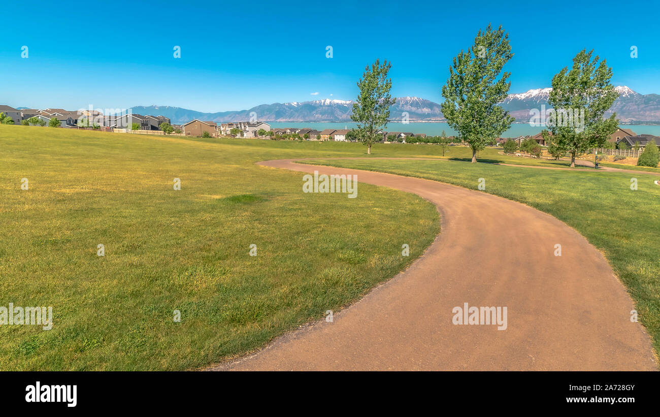 Panorama Lovely scenery with a pathway on a grassy terrain overlooking ...
