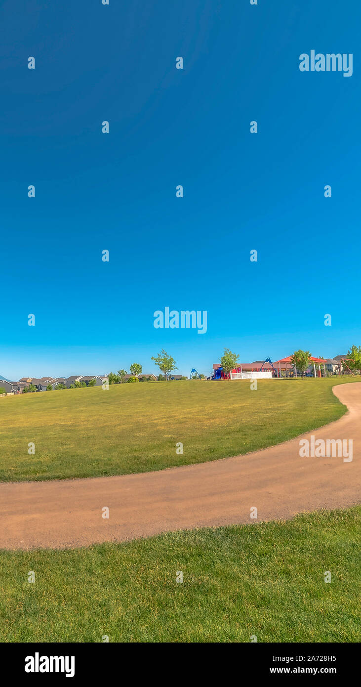 Vertical Pathway winding on a vast grassy terrain with lake and snow ...