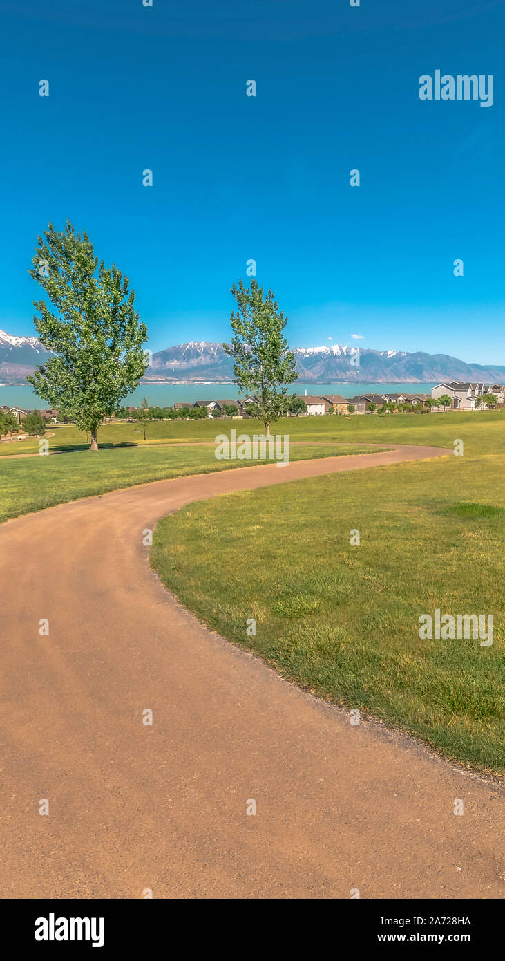Vertical frame Lovely scenery with a pathway on a grassy terrain ...