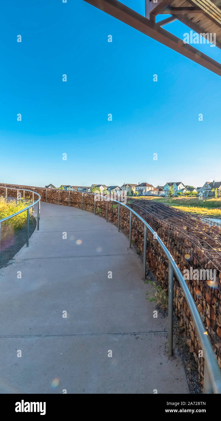 Vertical frame Concrete road with handrails under a metal bridge that ...