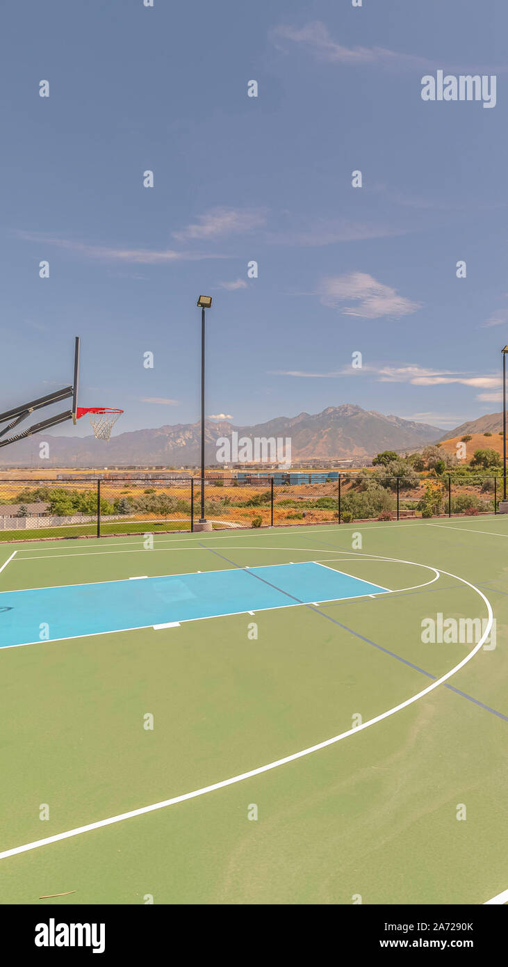 Vertical Outdoor turf basketball court on sunny, clear day Stock Photo ...