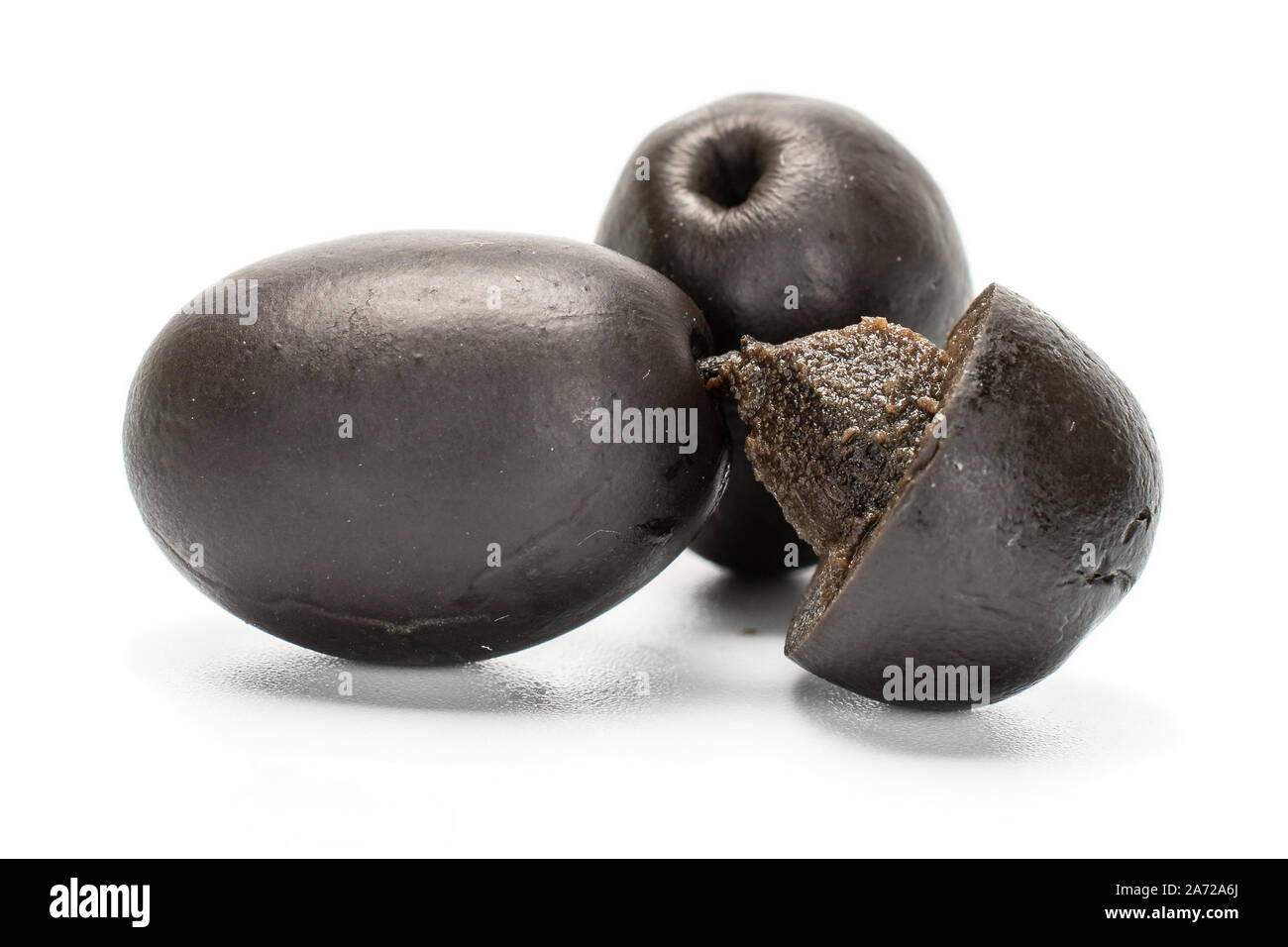 Group of two whole one half of canned black olive isolated on white ...