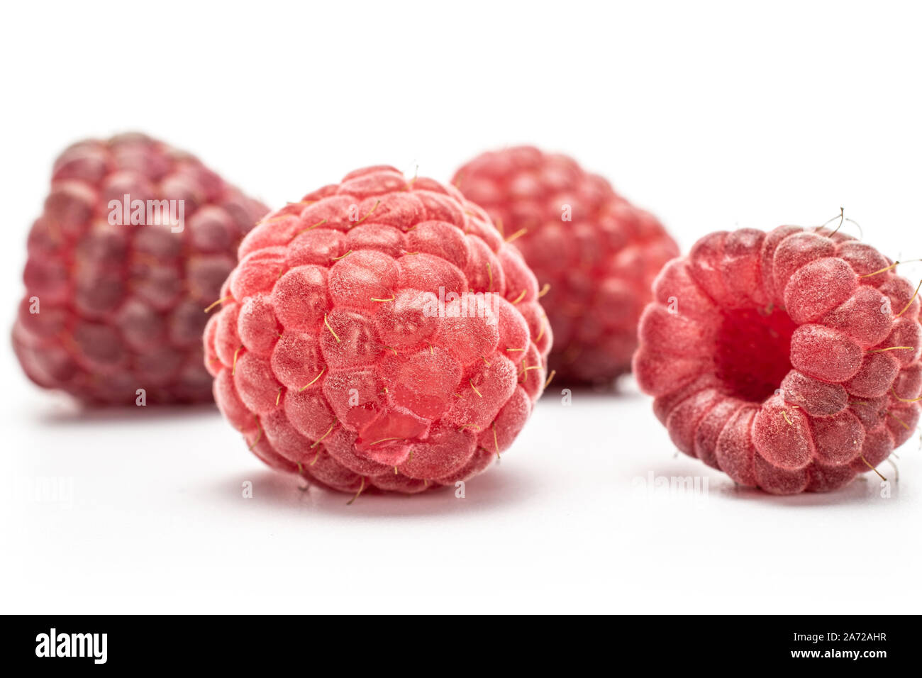 Group of five whole fresh crimson raspberry isolated on white ...