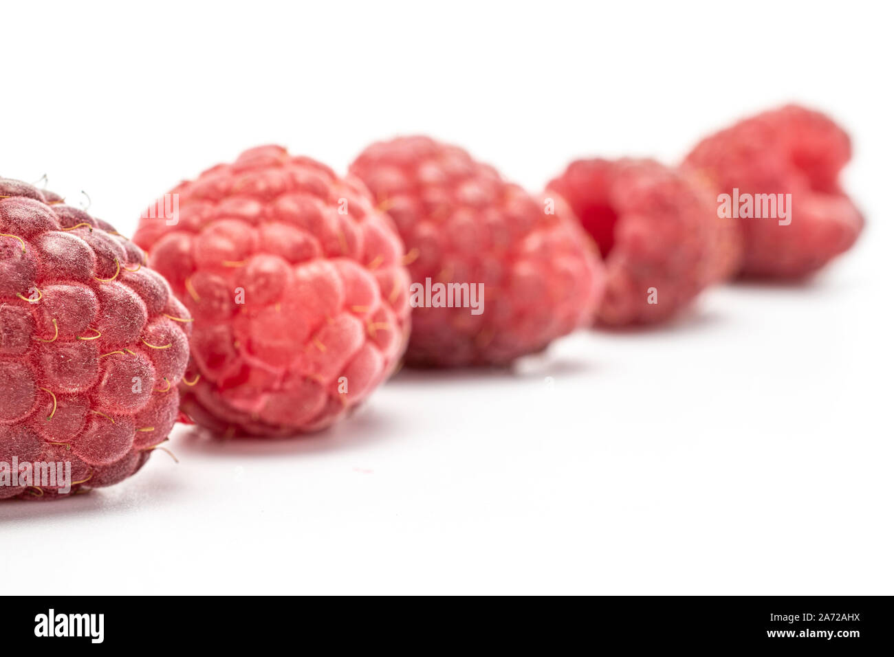 Group of six whole fresh crimson raspberry isolated on white background ...