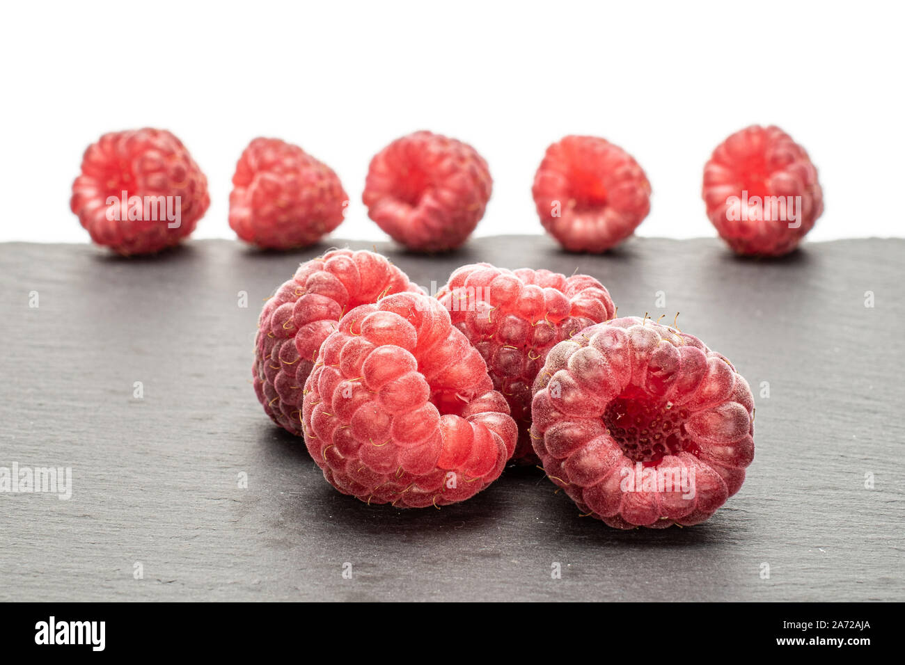 Group of two whole fresh crimson raspberry with steel spoon isolated on ...