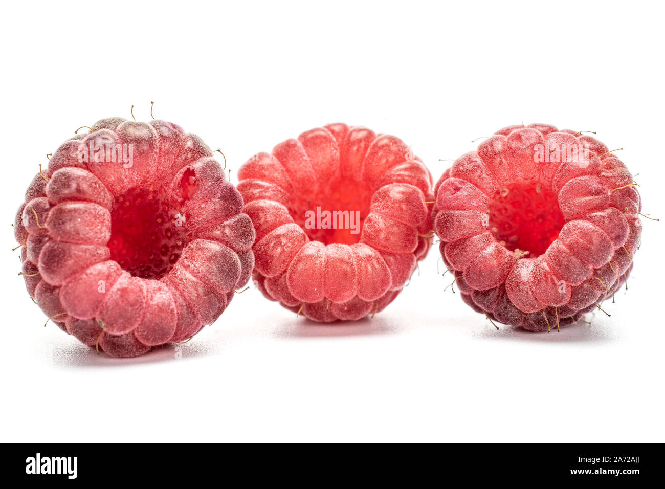 Group of three whole fresh crimson raspberry isolated on white ...