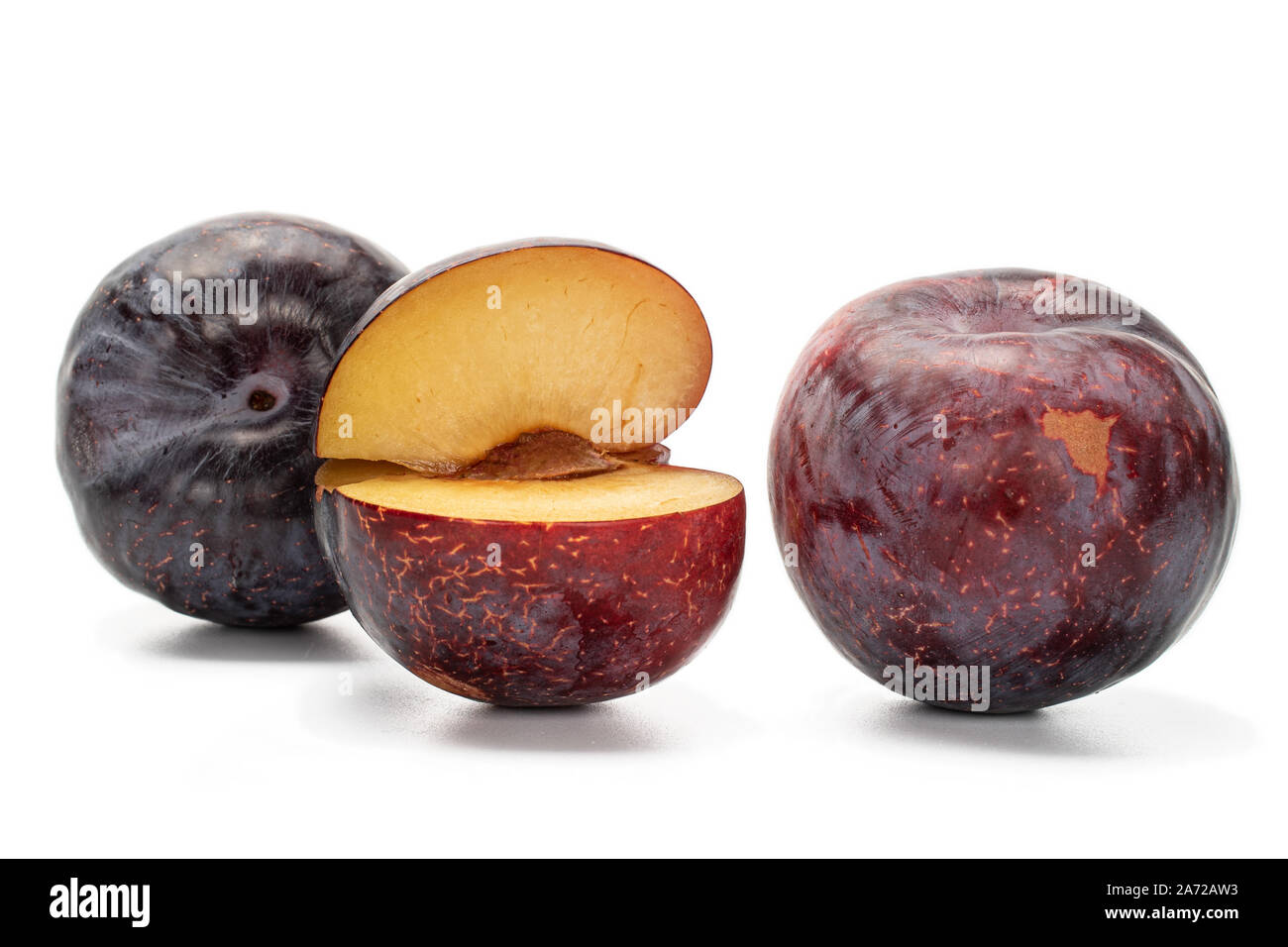 Group of two whole one half of fresh red plum isolated on white ...