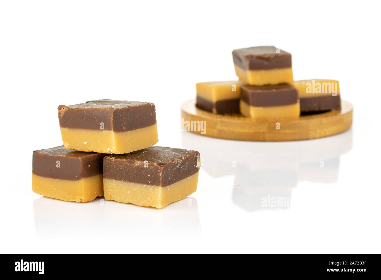 Group of seven whole sweet brown caramel chocolate candy on bamboo ...