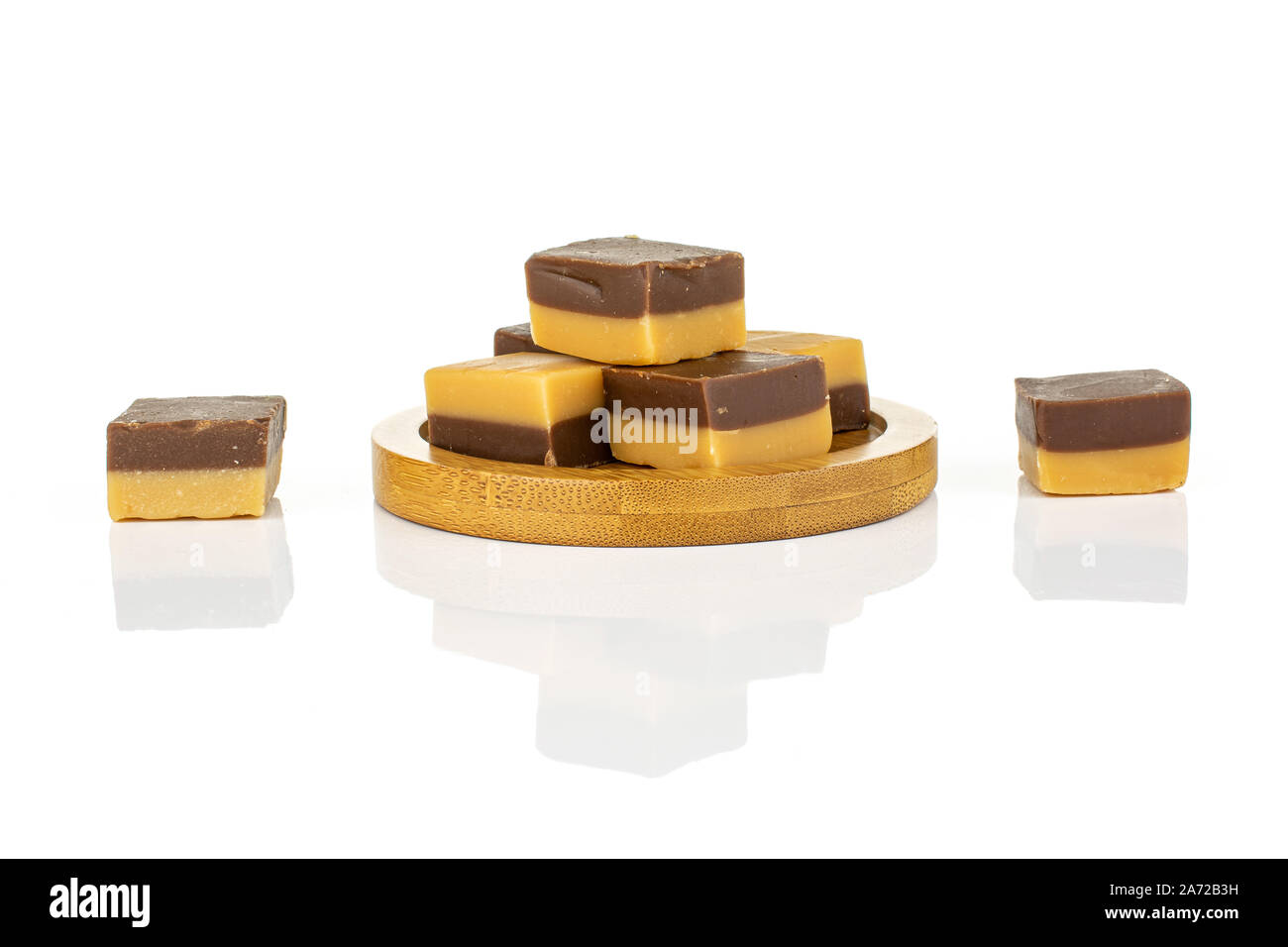Group of seven whole sweet brown caramel chocolate candy on bamboo ...