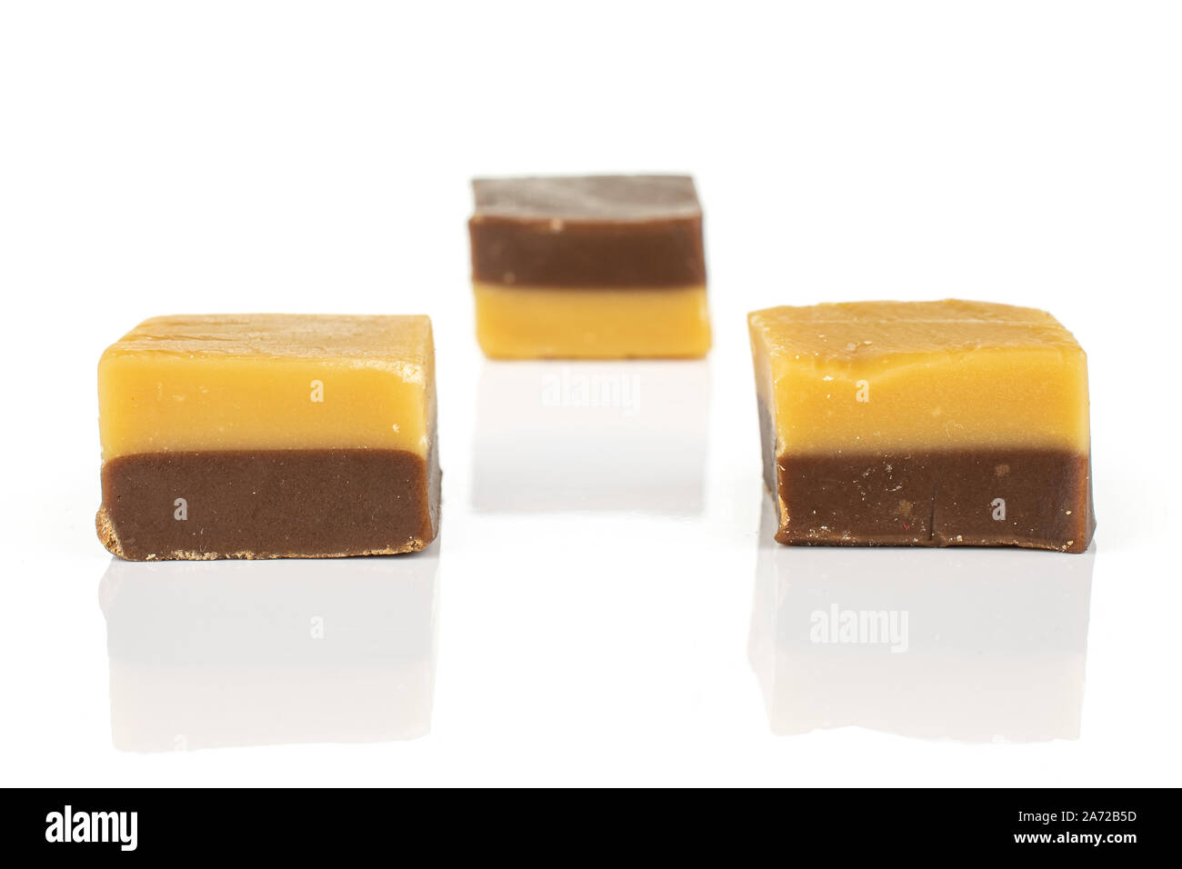 Group of three whole sweet brown caramel chocolate candy isolated on ...