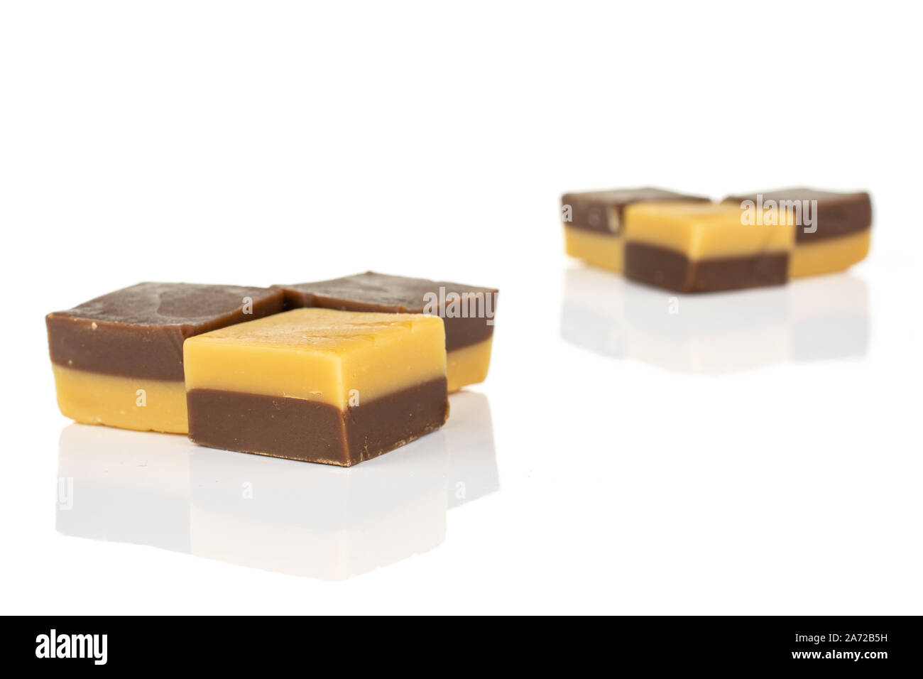 Group of six whole sweet brown caramel chocolate candy in two groups ...