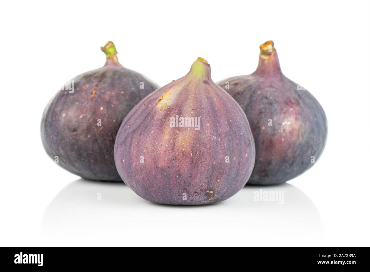 Group of three whole fresh purple fig isolated on white background ...