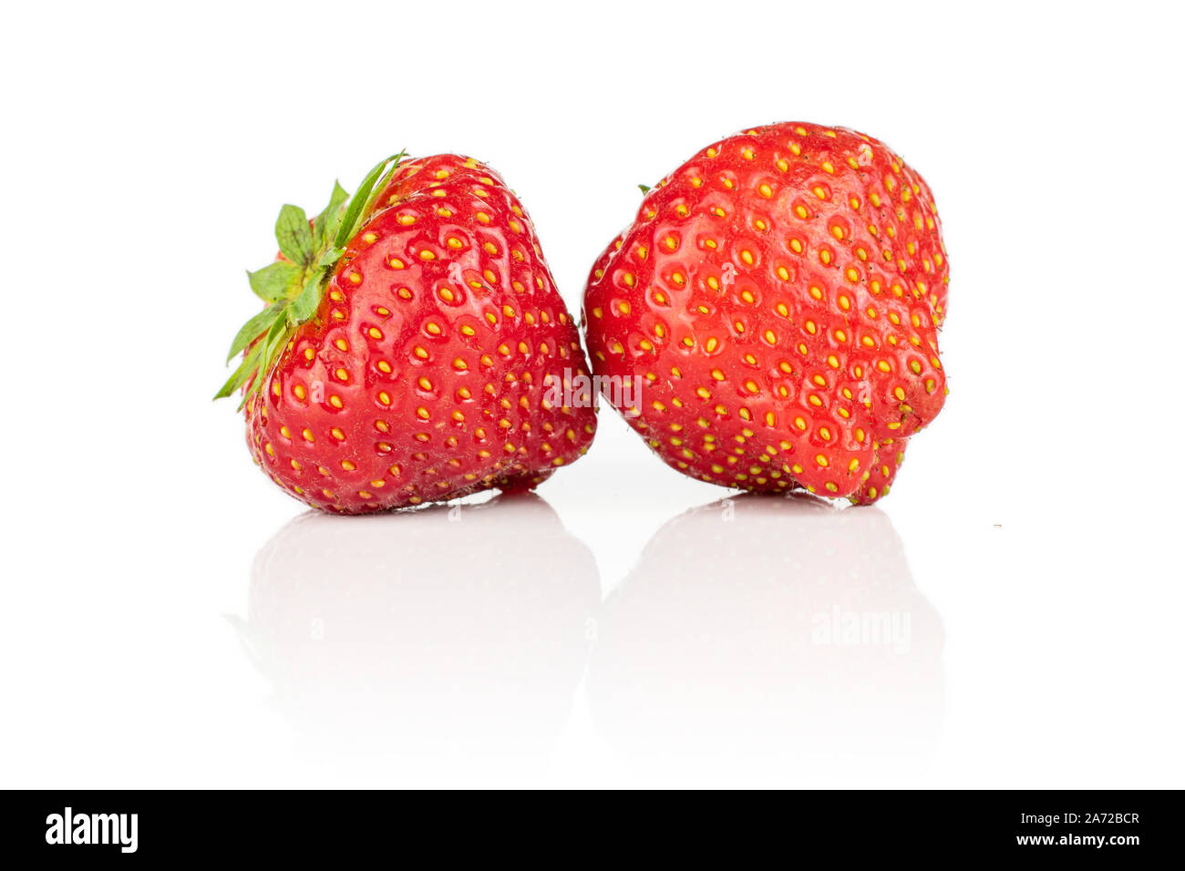 Group of two whole fresh red strawberry isolated on white background ...