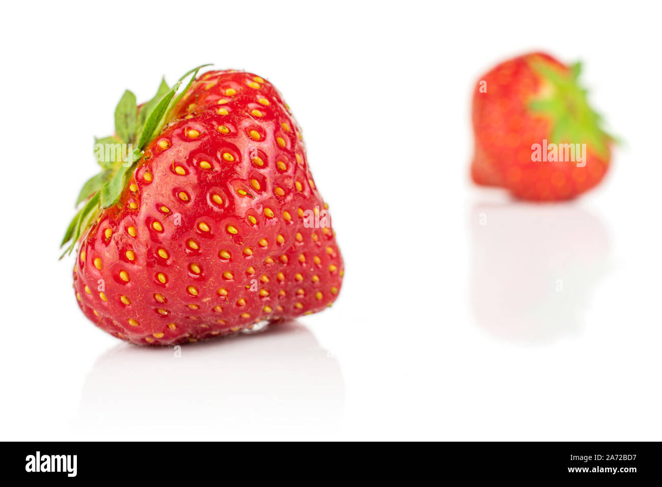 Group of two whole fresh red strawberry isolated on white background ...
