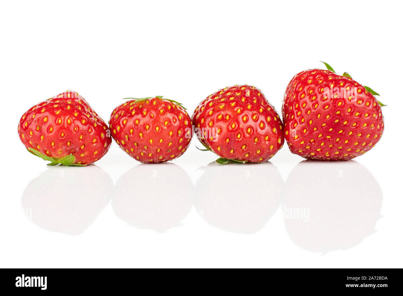Group of four whole fresh red strawberry isolated on white background ...