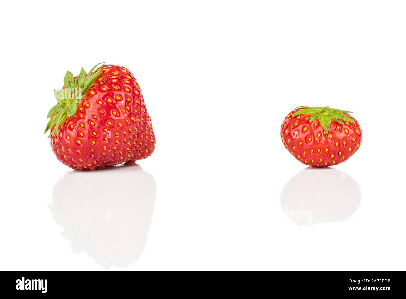Group of two whole fresh red strawberry isolated on white background ...
