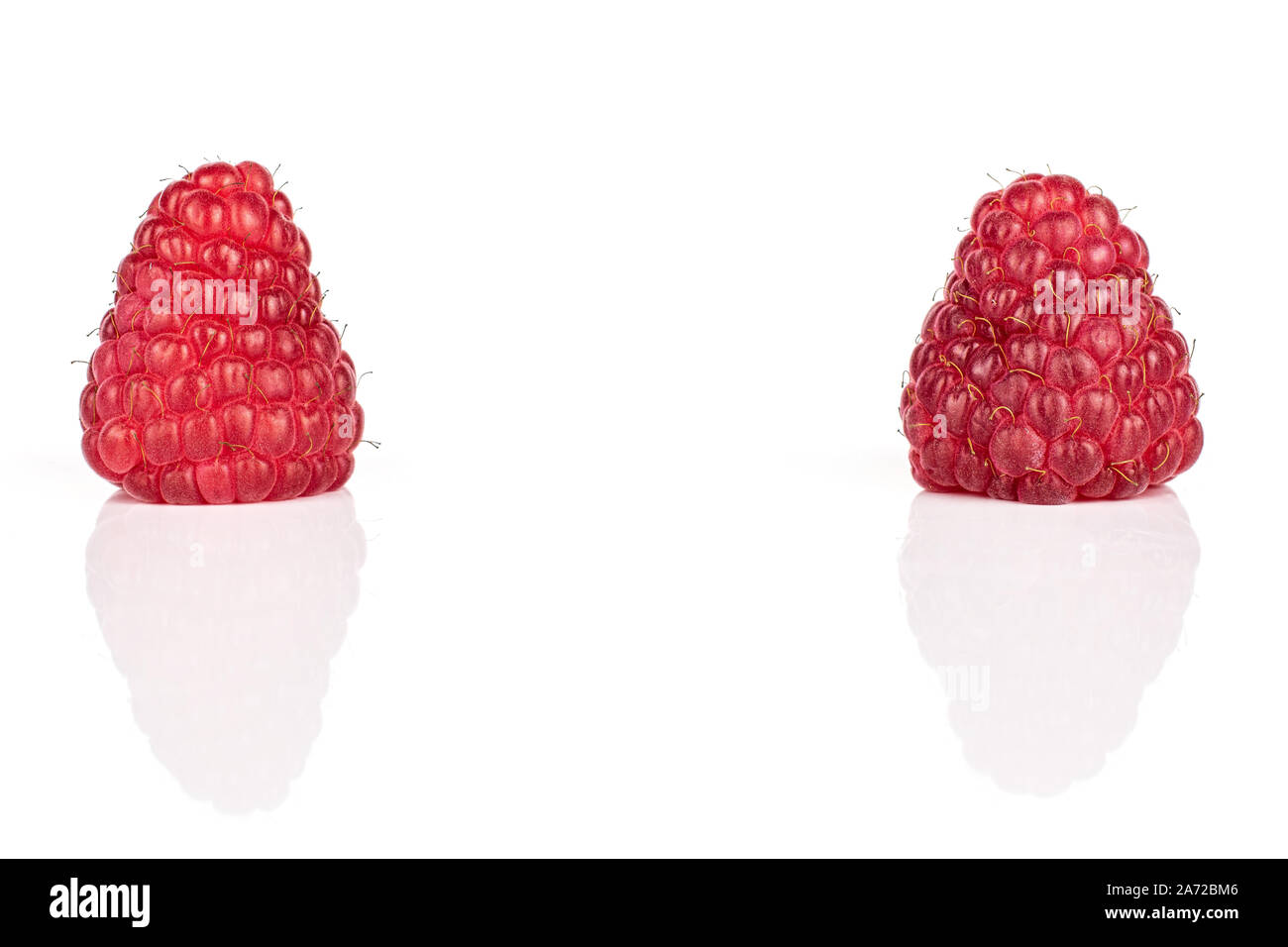 Group of two whole fresh red raspberry isolated on white background ...