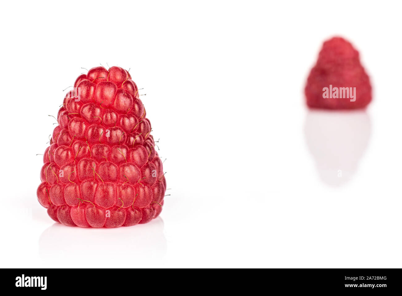 Group of two whole fresh red raspberry isolated on white background ...