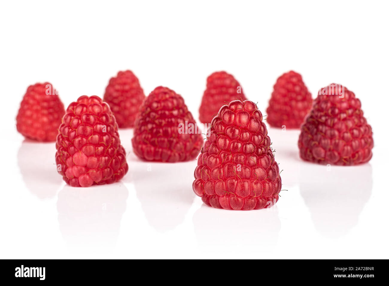 Group of eight whole fresh red raspberry isolated on white background ...