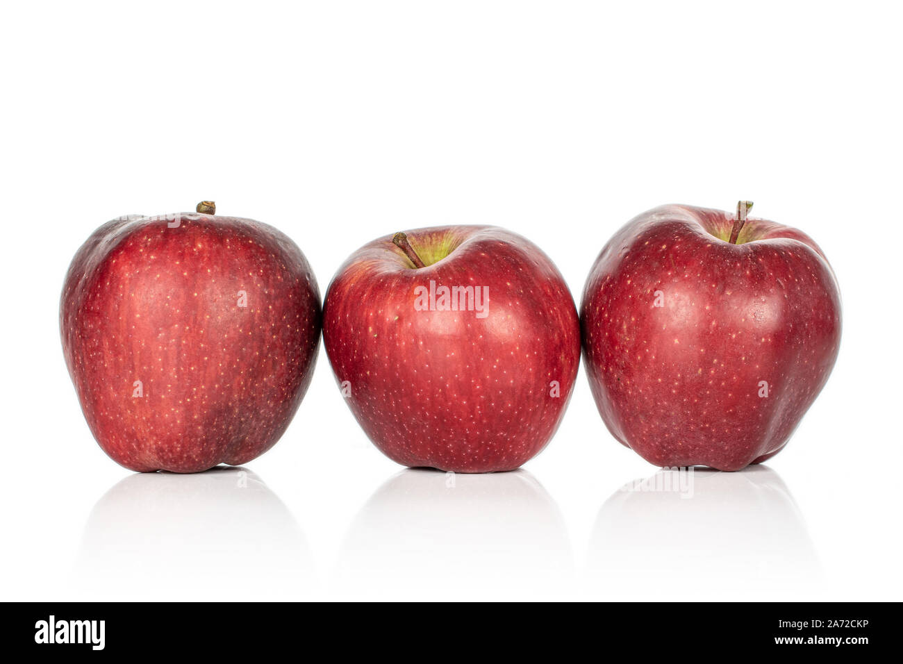 Group of three whole fresh apple red delicious isolated on white ...
