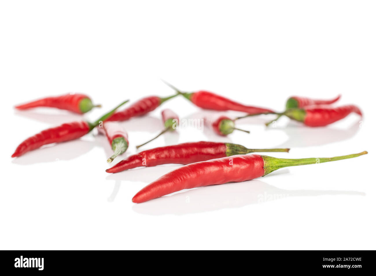 Lot of whole hot red chili isolated on white background Stock Photo - Alamy