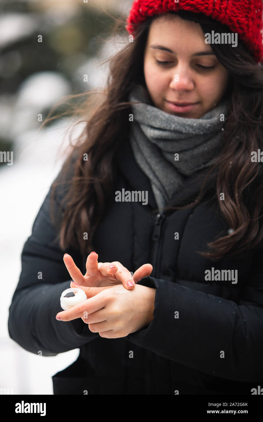 woman using cream at cold winter weather. skin protection Stock Photo ...