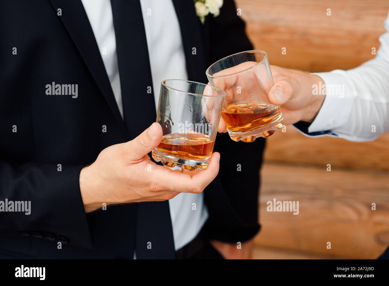 Two glasses with whiskey in men's hands. Alcohol. Celebration Stock ...