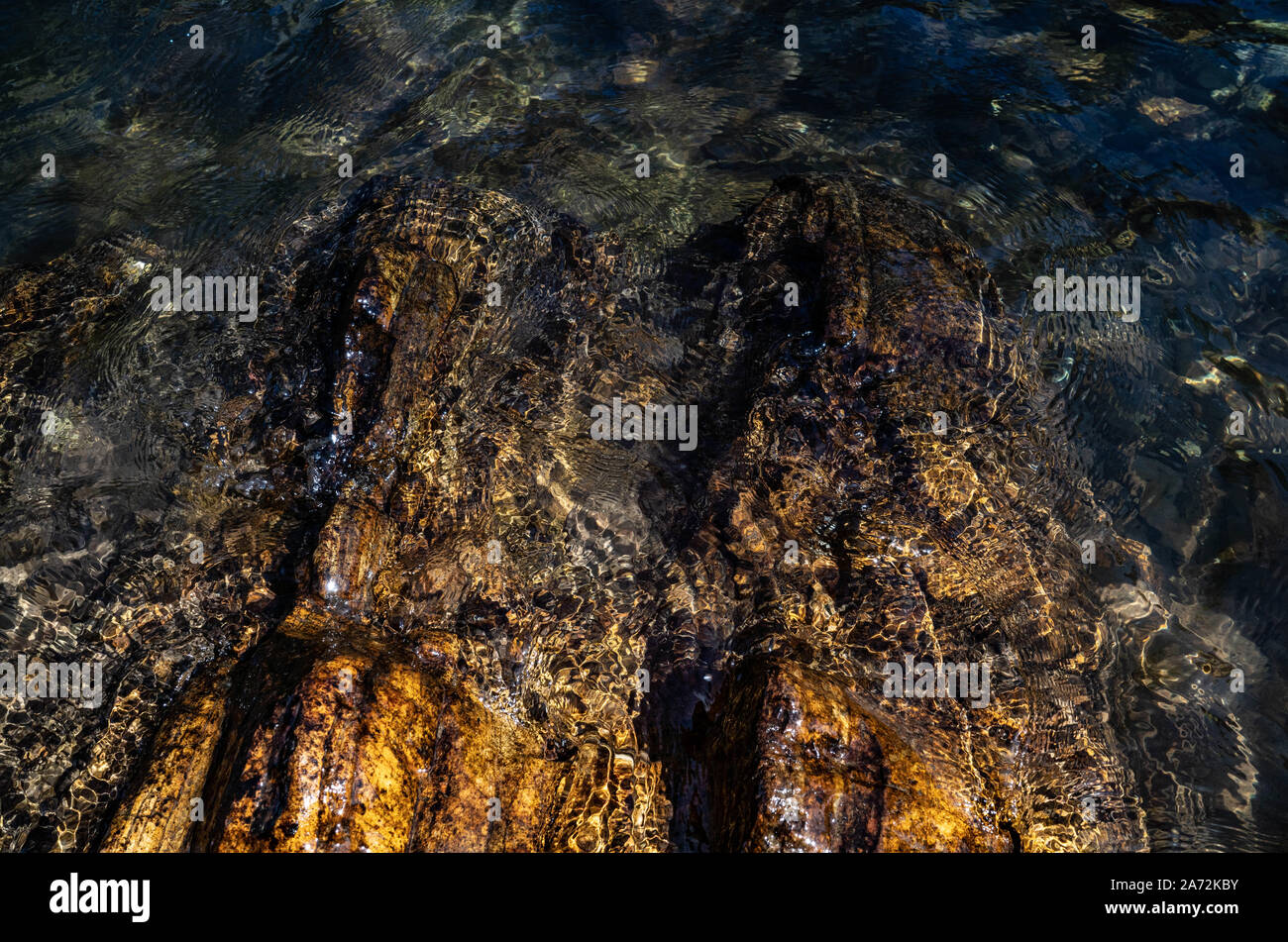 Top down look of Water flowing over uniquely formed rocks leaving ...