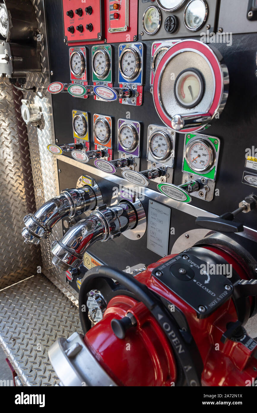 Valves and pump panel on the side of a red fire truck Stock Photo - Alamy