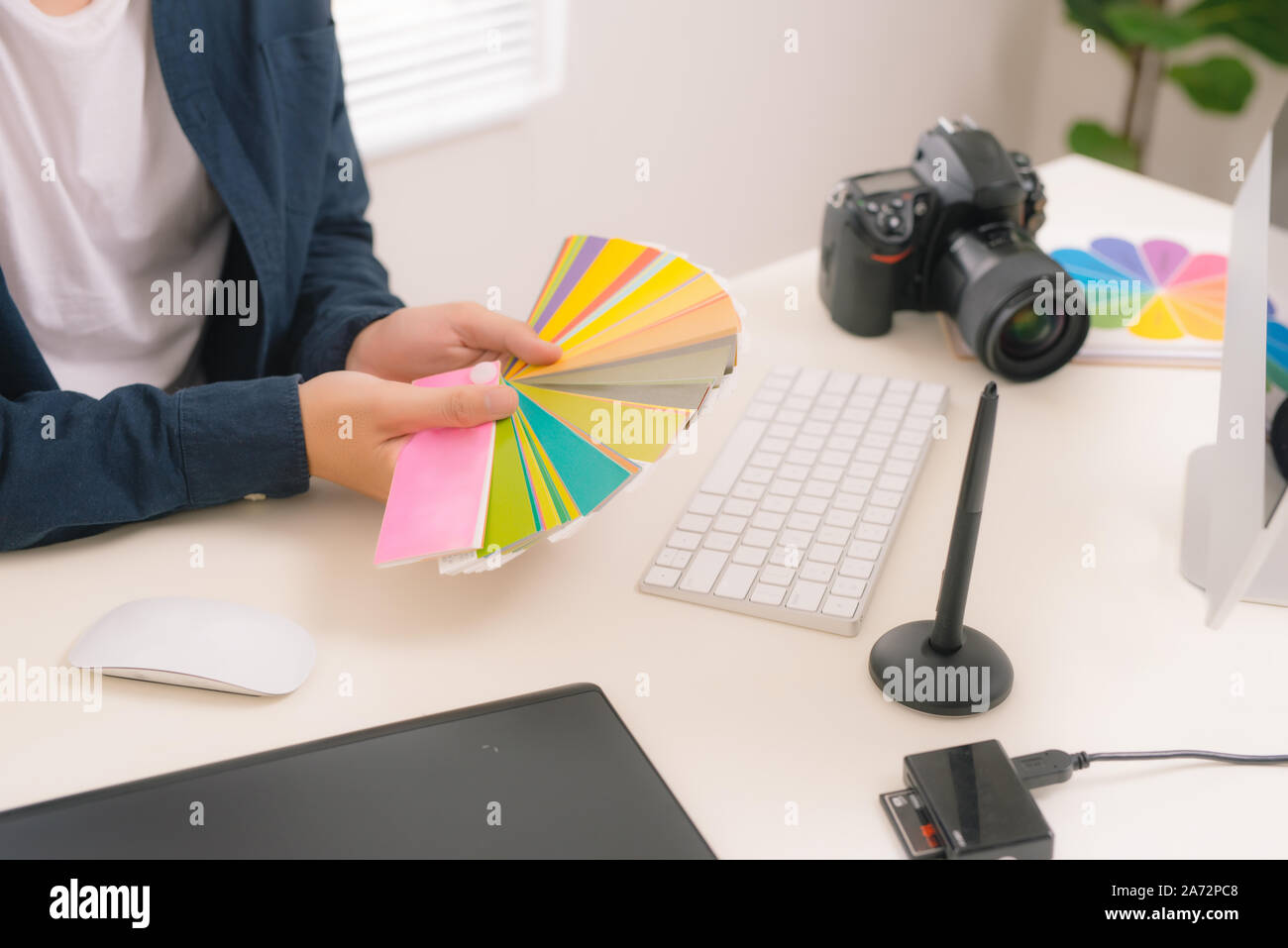 Hand of male designer working at his desk using stylus and digital ...
