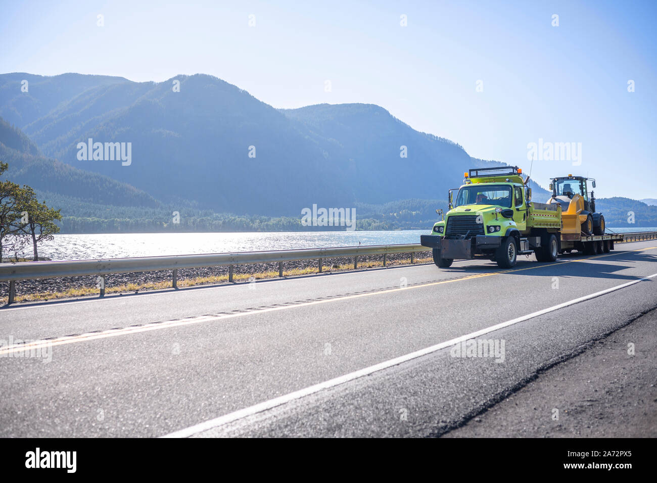 Small compact bright green semi tip truck transporting multifunctional ...