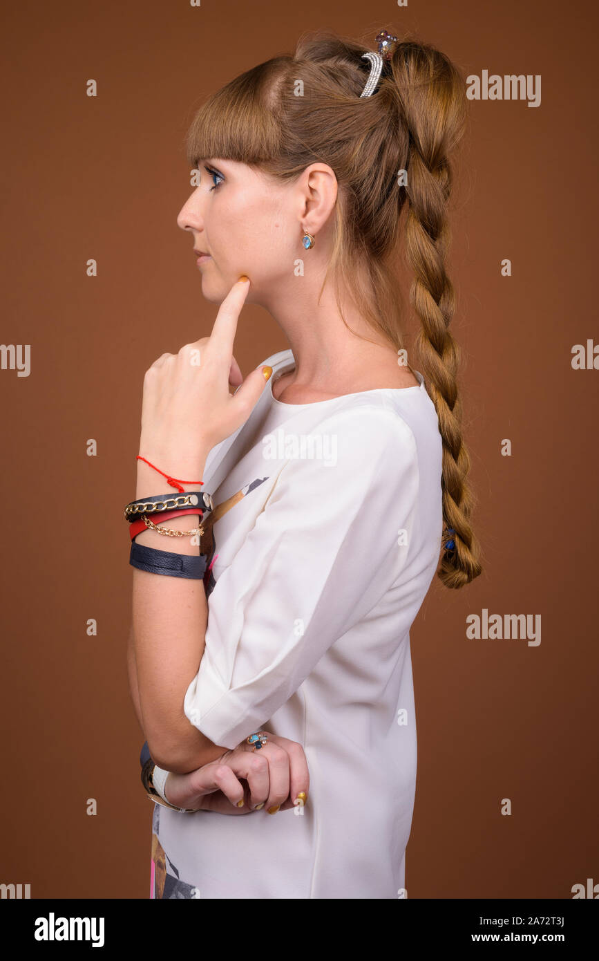 Profile view of beautiful blonde woman with braided hair Stock Photo ...