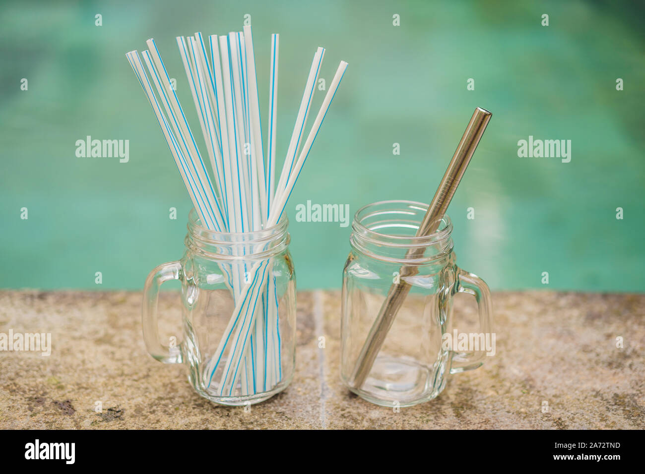 Steel drinking vs disposable straws on pool background. Zero waste ...