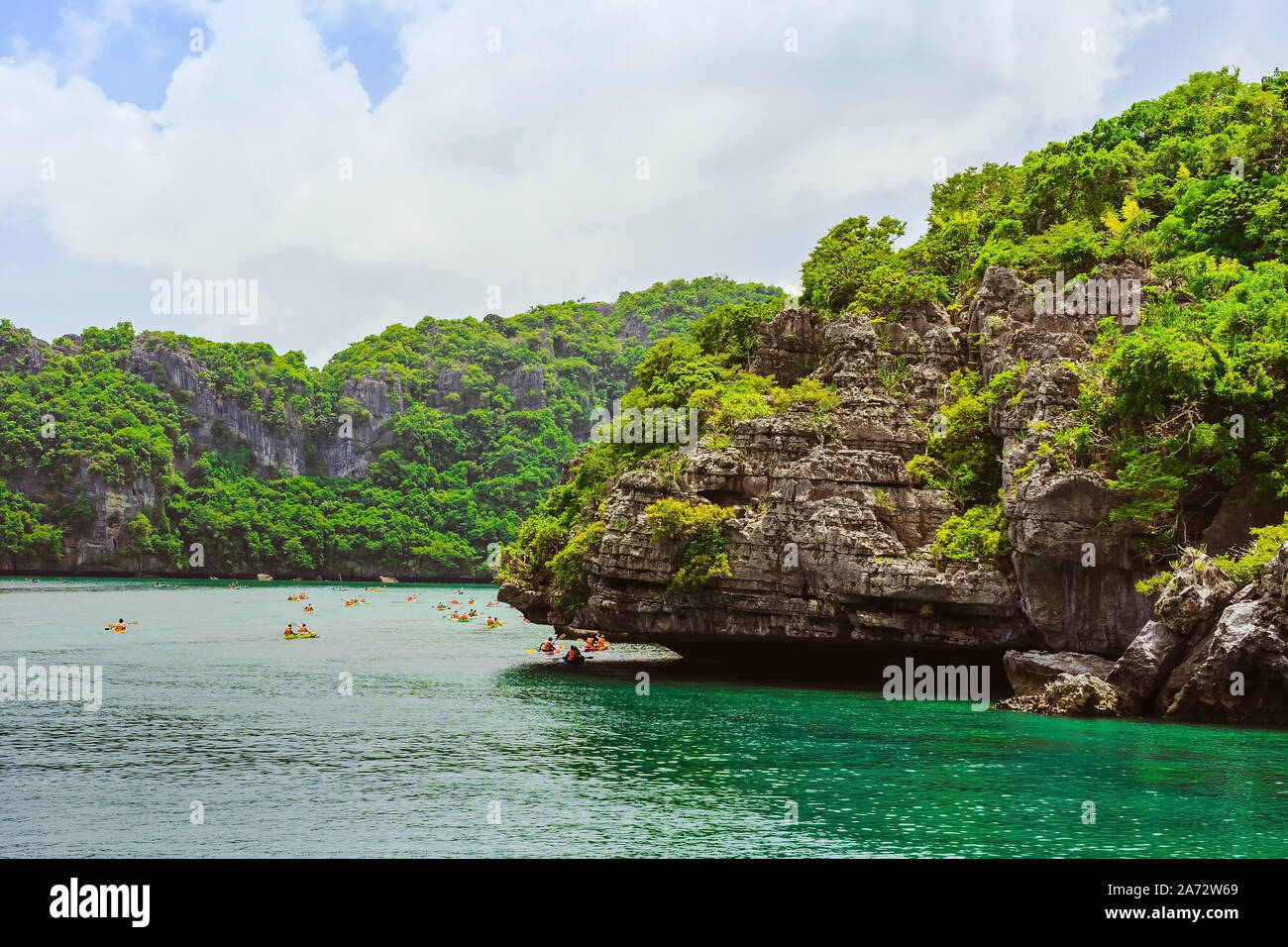 Tourist kayaking in blue Idyllic turquoise ocean to explore near the ...