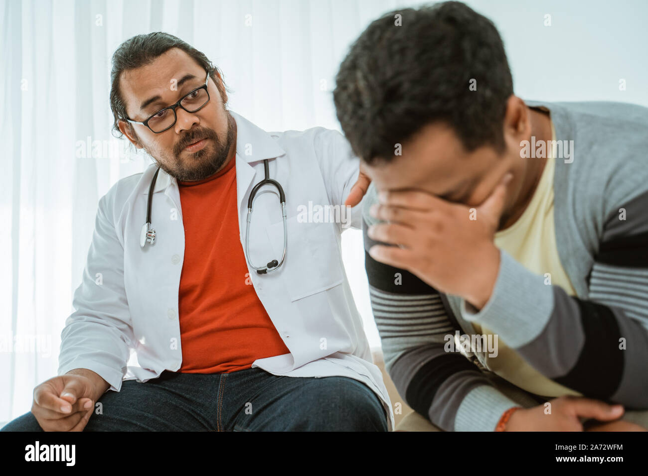 depress patient consulting with his doctor in his office Stock Photo ...