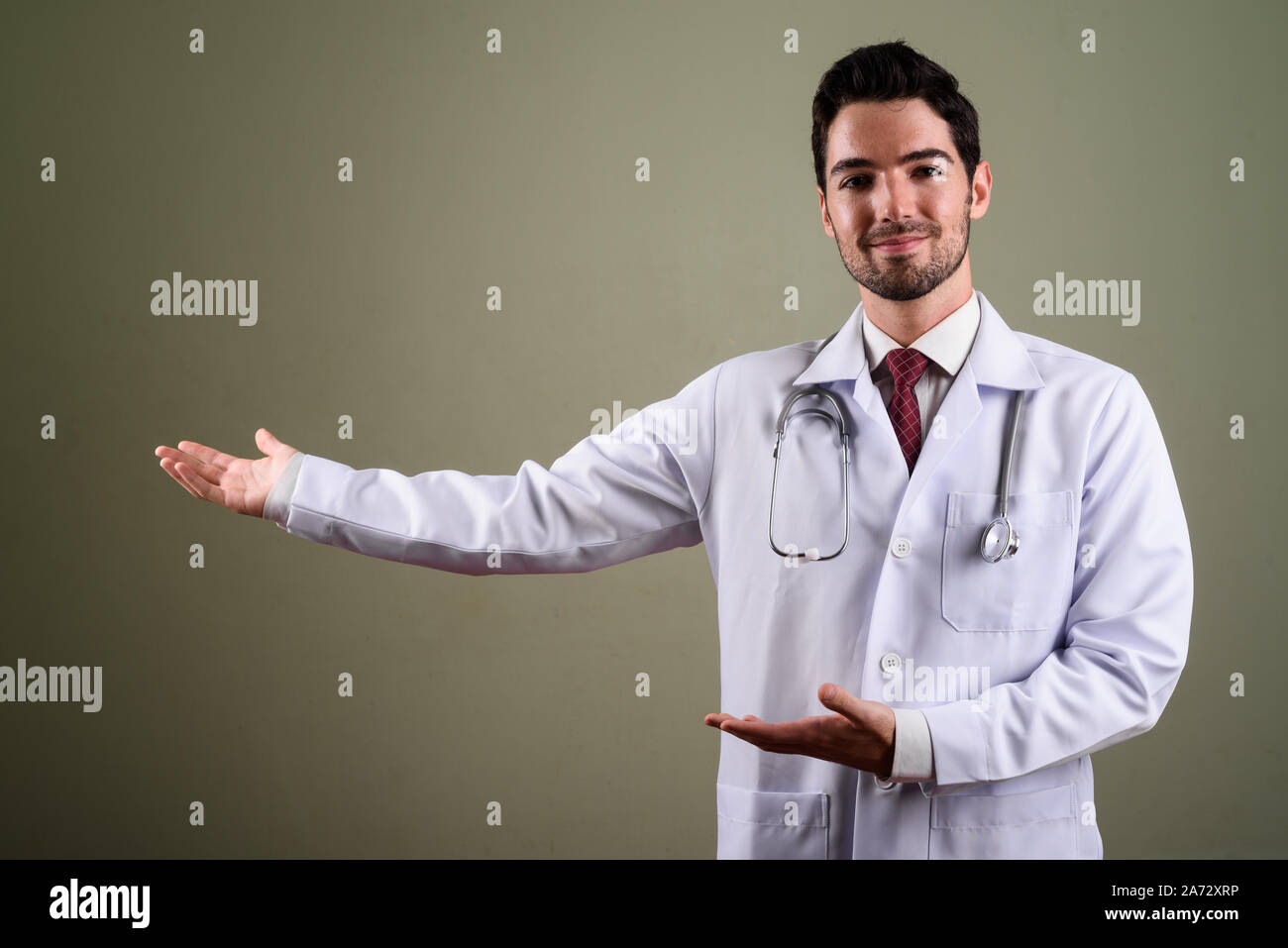 Portrait of young handsome man doctor with stubble beard Stock Photo ...