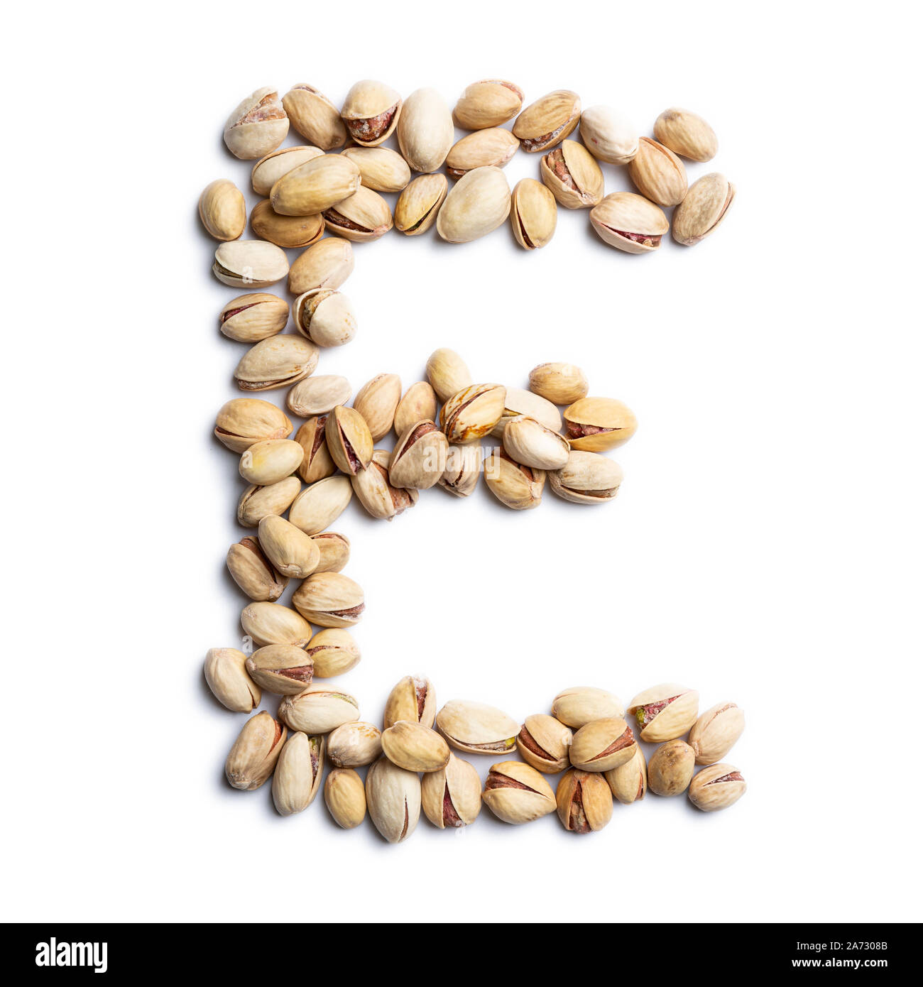 The letter "E" of the English alphabet from a unpeeled pistachios on a ...