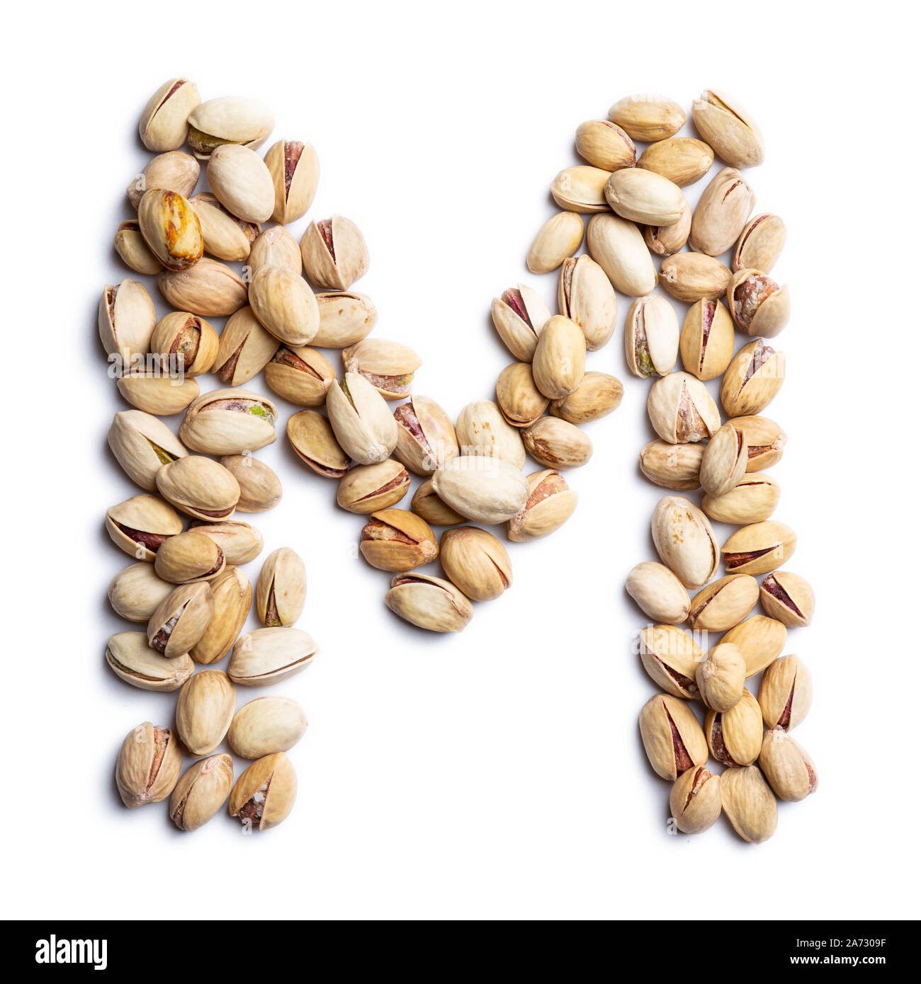 The letter "M" of the English alphabet from a unpeeled pistachios on a ...